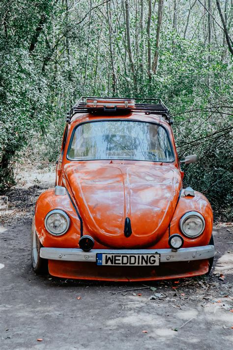 Red Volkswagen Beetle Parked At Road Side Near Pedestrian Lane · Free