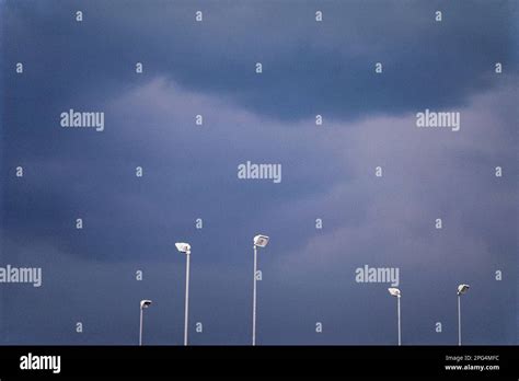 Cloudy Stormy Skies Is Backdrop For Alien Looking Light Poles Randomly