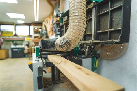 Wooden Desk Placed On Sawdust Extractor Machine Table In Carpentry