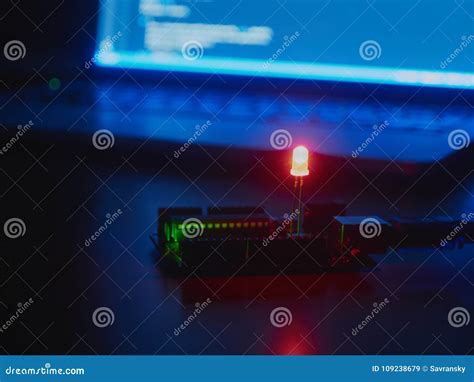 arduino with red light emitting diode against a laptop screen stock image image of laptop