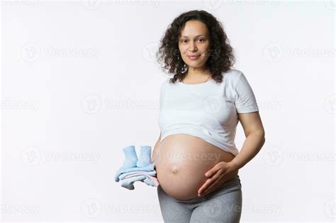 Beautiful Latina Pregnant Woman Smiling At Camera Touching Her Big