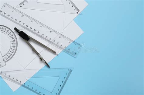 Flat Lay Composition With Different Rulers And Compass On Light Blue