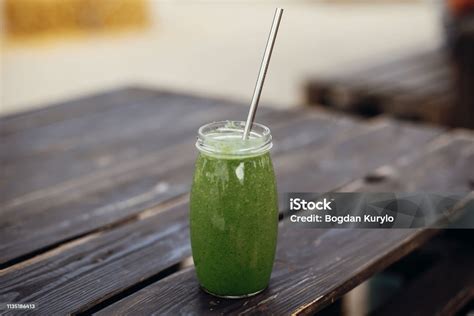 길거리 음식 축제에서 나무 테이블에 금속 재사용 가능한 빨 대와 유리 항아리에 건강 한 시금치 스무디 제로 폐기물 개념입니다 더운 여름날의 상쾌한 음료 0에 대한 스톡 사진