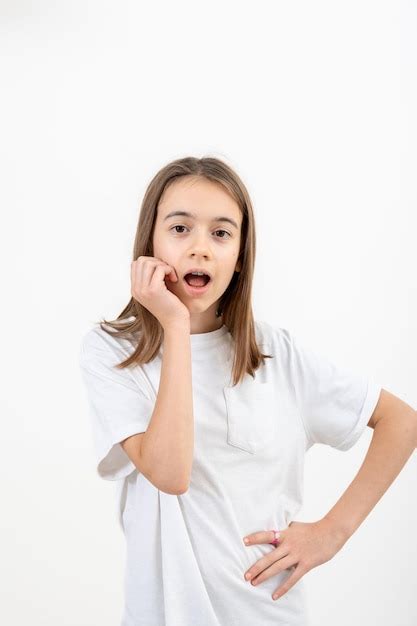 Premium Photo A Girl With Mouth Wide Open Holds Her Hand Near Face On