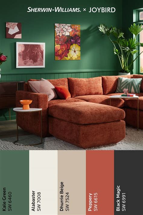 A Living Room With Green Walls And Orange Furniture
