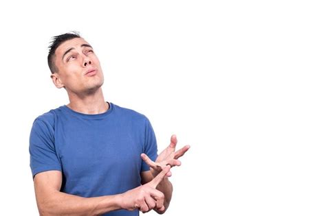 Man With Expression Of Concentration While Counting With His Fingers