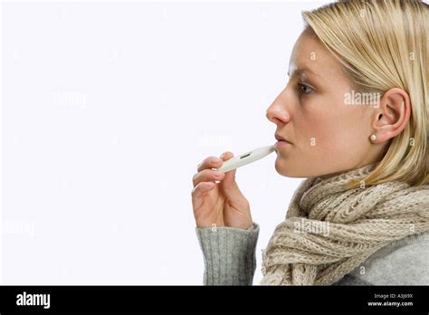 Woman Using Thermometer Stock Photo Alamy