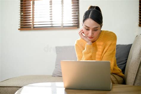Attractive Asian Woman Remote Working At Home Focusing On Her Tasks On