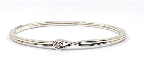 Lot A Sterling Silver And Diamond Hinged Bangle