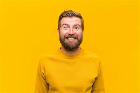 Premium Photo Young Blonde Man Looking Happy And Goofy With A Broad Fun Loony Smile And Eyes