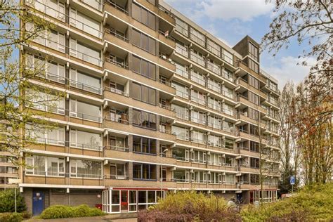 A Large Apartment Building With Many Balconies And Trees Stock Image