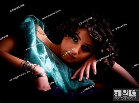 Beautyfull Young Girl With Dark Curly Hair And A Make Up In Peacock