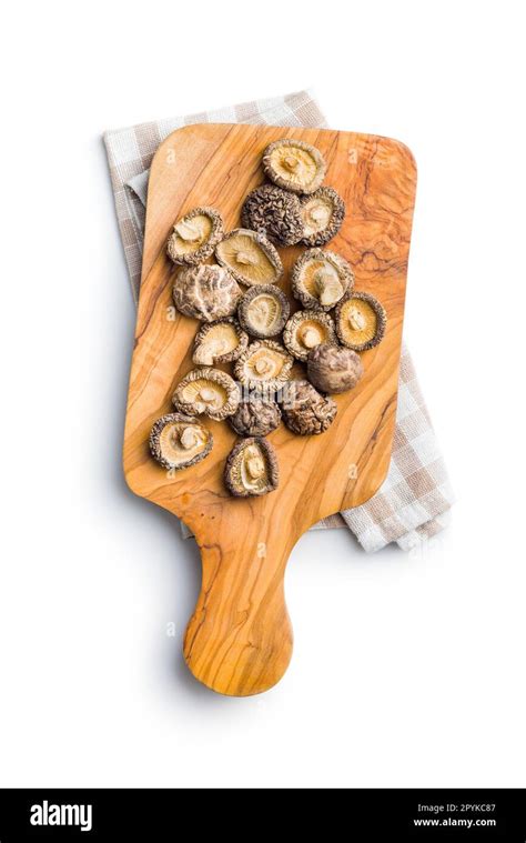 Dried Shiitake Mushrooms On Cutting Board Isolated On White Background