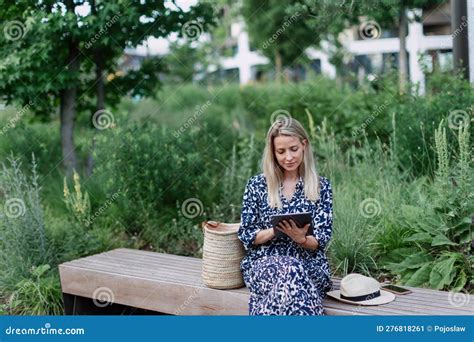 Mature Woman Sitting In Park Bench Enjoying Time For Herself Stock