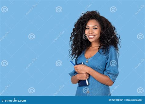 Young African Woman With Notebook Smiling On Copy Space Blue Bac Stock