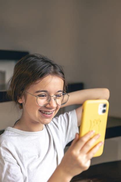 A Teenage Girl In Glasses And Braces Communicates Via Video Call Free