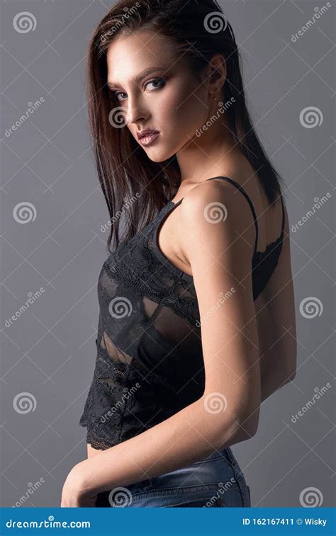 Girl In Lace Top And Ripped Jeans In Profile Stock Image Image Of