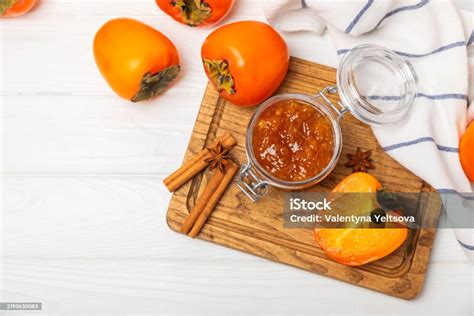 나무 질감의 테이블에 잘 익은 감을 얇게 썰어 놓은 감잼 맛있는 감 잼 마멀레이드 건강한 과자 채식주의 클로즈업 텍스트를 위한 공간입니다 공간을 복사합니다 감에 대한 스톡