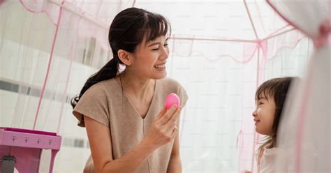 아시아 어머니는 어린 소녀 딸에게 집에서 텐트에서 색에 대해 가르칩니다 아름다운 사랑하는 부모는 말하기 기술을 배우고 개발하기