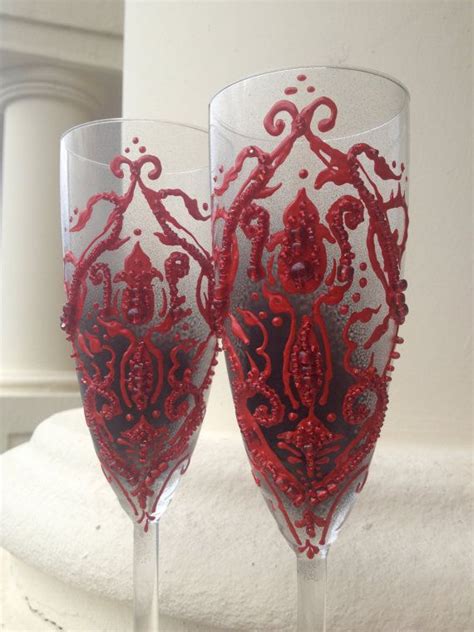 Wedding Champagne Glasses Toasting Flutes With A Dark Red Damask On A