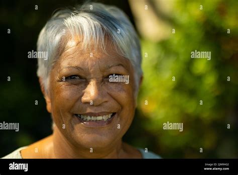 Close Up Portrait Of Smiling Biracial Senior Woman With Short Gray Hair
