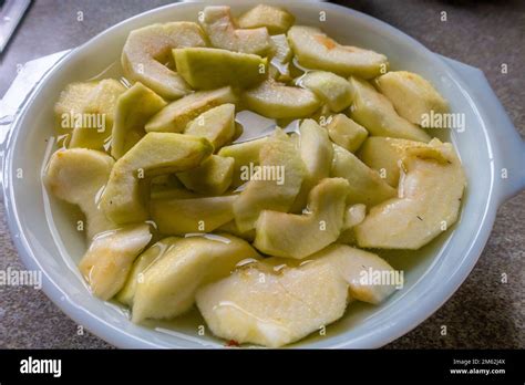 Peeled And Sliced Apples In A Dish Of Water Ready To Make Apple Sauce