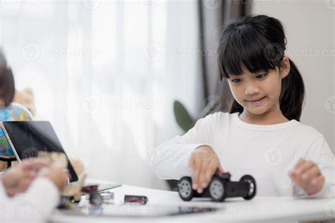 Two Asian Students Learn Coding Robot Cars And Electronic Board Cables