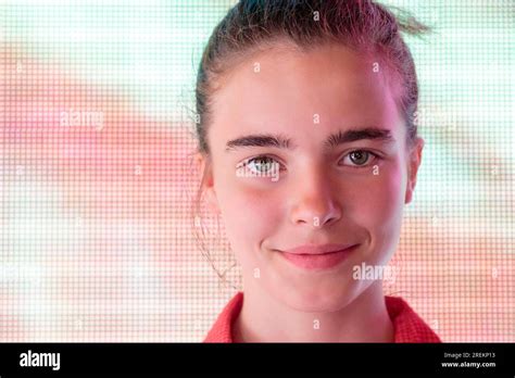 Portrait Of A Smiling Teenage Girl In Front Of A Digital Screen Stock
