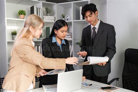 Business Team Collaborating On Data Analysis With Graphs In A Modern Office Setting Stock Image