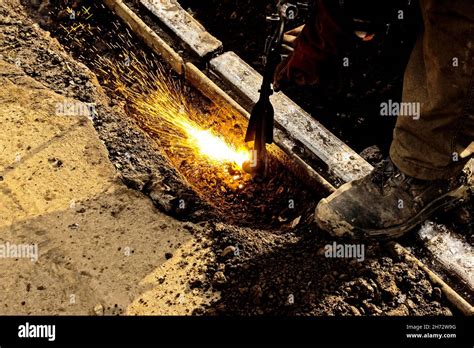 Close Up Of The Hand Of An Industrial Worker Working On The Process Of Cutting Rails A Male