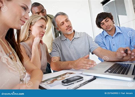 Focused On The Future A Group Of Business People Sitting Around A