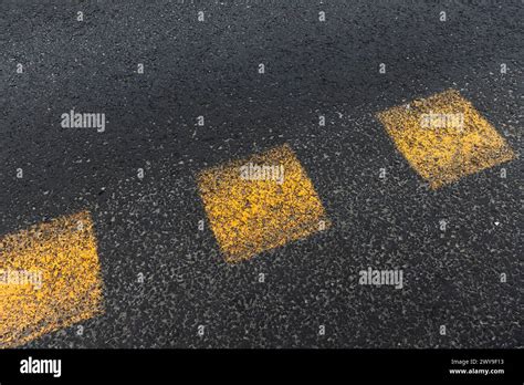 Pedestrian Crossing Road Marking Yellow Squares On Dark Tarmac