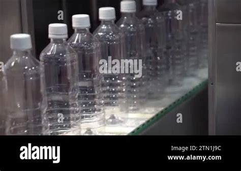 The Plastic Bottle Filling Process In The Conveyor Belt The Drinking Water Bottle Manufacturing