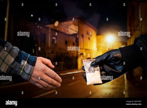 Drug Dealer Selling Junkie Man Hand Holds Plastic Packet Or Bag With