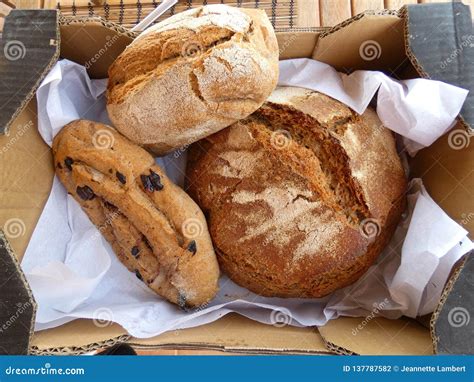 Three Loaves Of Different Types Of Bread In Wheat Field Homemade