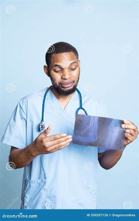 Medical Assistant Examining X Ray Scans And Providing Diagnosis For A