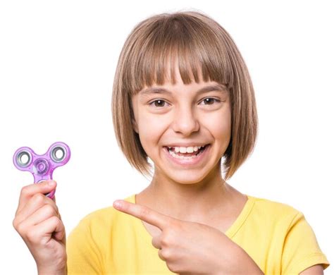 Premium Photo Young Girl Holding Popular Fidget Spinner Toy Close Up