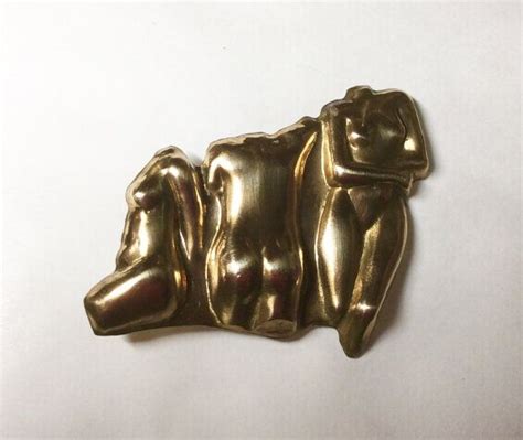 A Gold Colored Metal Object On A White Surface