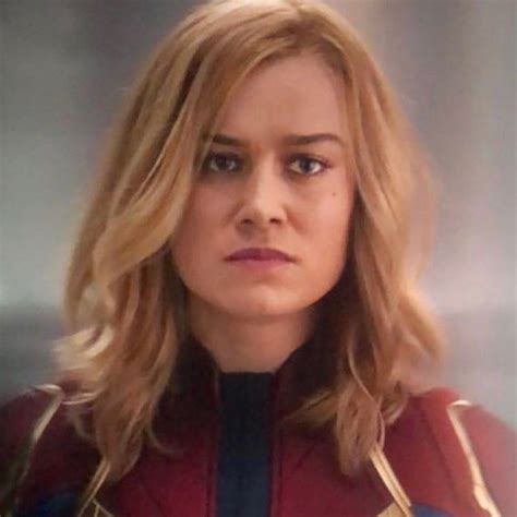 The Captain Is Looking Into The Camera With Her Eyes Closed And She Has