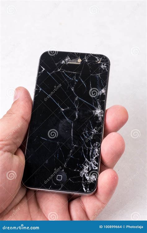 Black Smartphone With Cracked And Smashed Lcd Touch Screen In The Hand