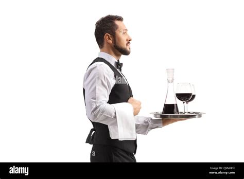 Profile Shot Of A Waiter Carrying A Red Wine Decanter On A Silver Tray