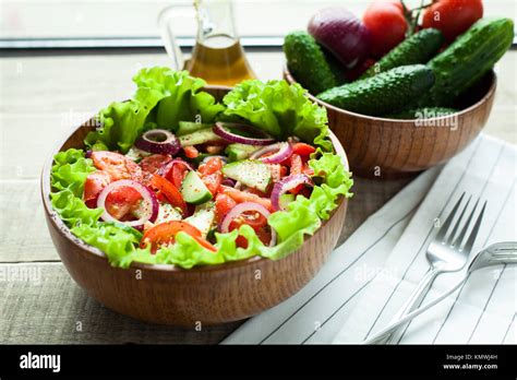 Rustic Salad Of Fresh Tomatoes Cucumbers Red Onions And Lettuce