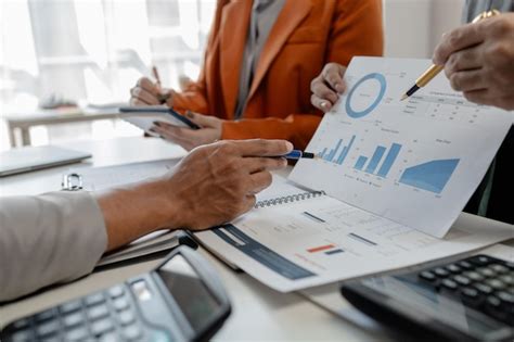 Premium Photo Calculate The Numbers According To The Report Sent To The Meeting They Are