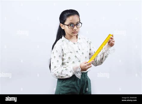 Young Girl Teaching Portrait Of Happy Indian Teenage Girl Holding A Measuring Scale In Hand And