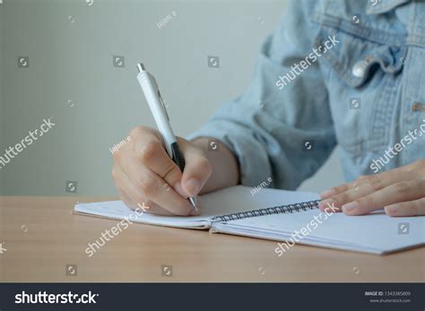 Female Hand Pen Writing On Notebook Stock Photo 1343385809 Shutterstock