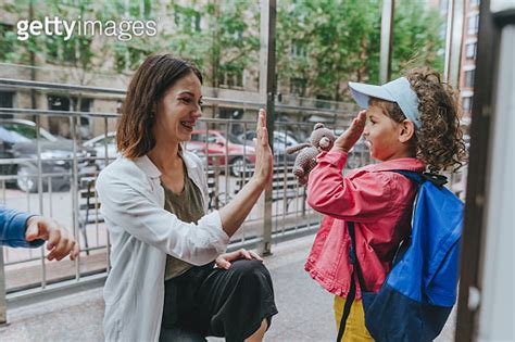 Happy Smiling Woman Teacher Greeting Elementary School Students 이미지