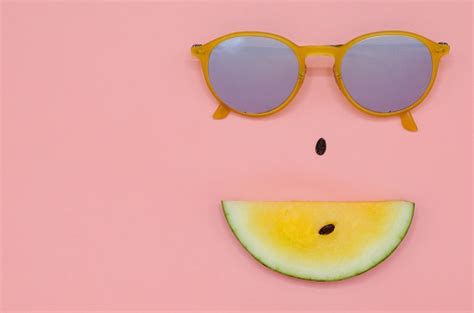 노란 수 박과 그 씨앗의 슬라이스 오렌지 컬러 선글라스 얼굴과 분홍색 배경 텍스트 위한 공간에 넣어 입으로 설정 합니다 배경