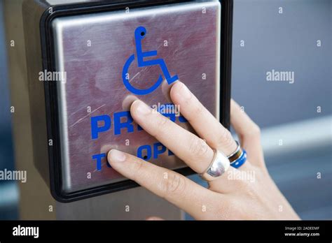 Woman S Hand On A Disability Access Door Button Stock Photo Alamy