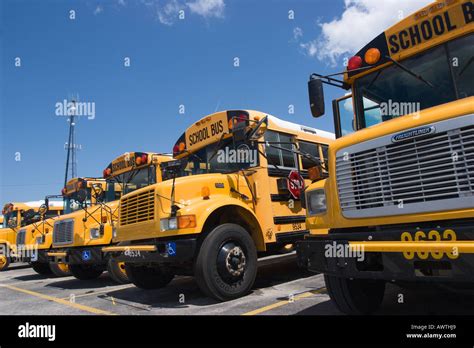 A Variety Of Different Types Of School Buses Fill The Lot Waiting To Be