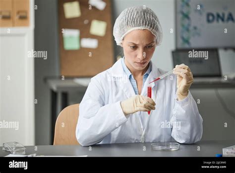 Portrait Of Female Lab Technician Performing Experiments With Red Liquid In Test Tube Copy